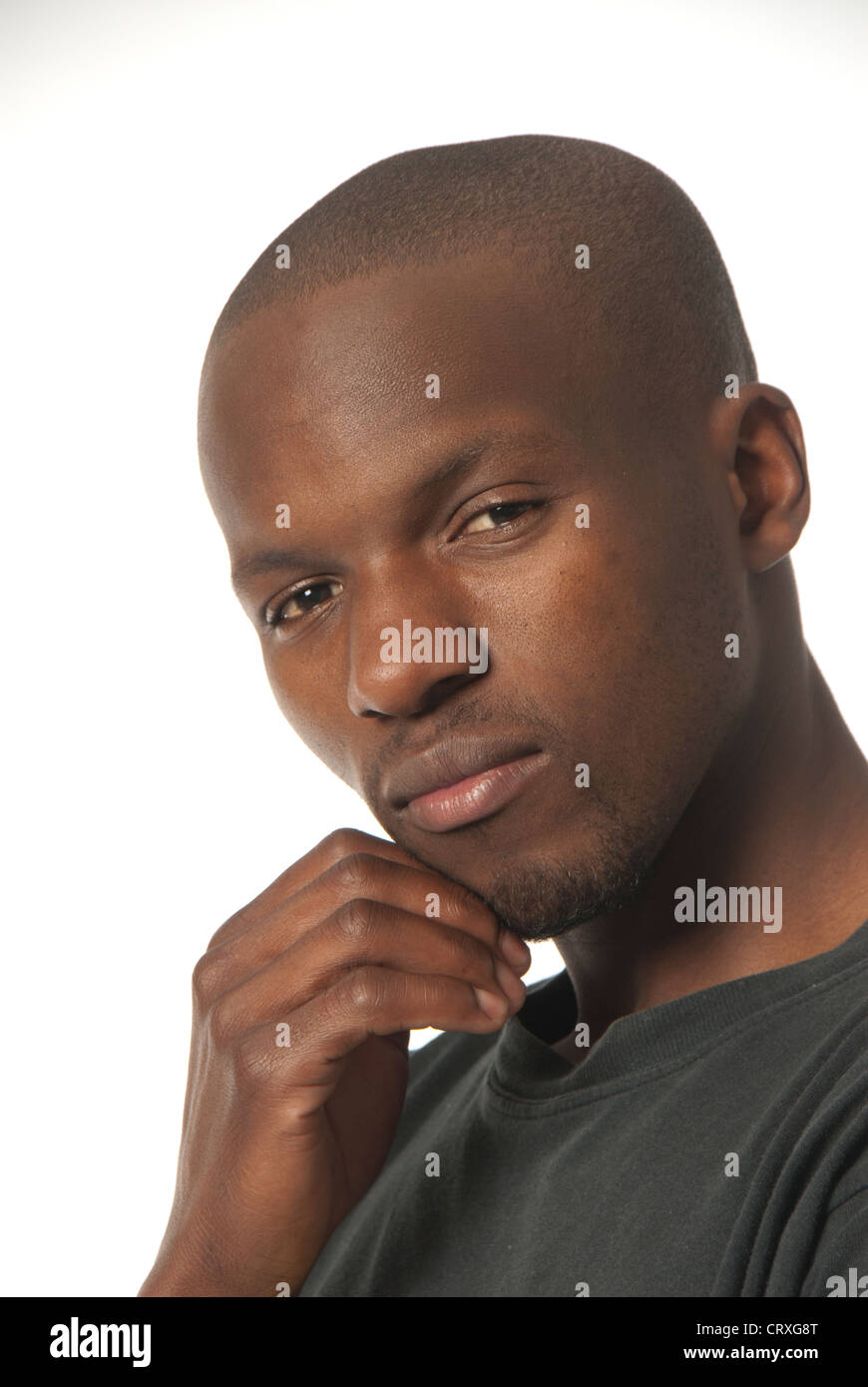 African man with shaven head deep in thought Stock Photo - Alamy