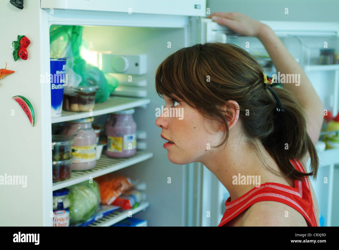 Young woman on the fridge Stock Photo - Alamy