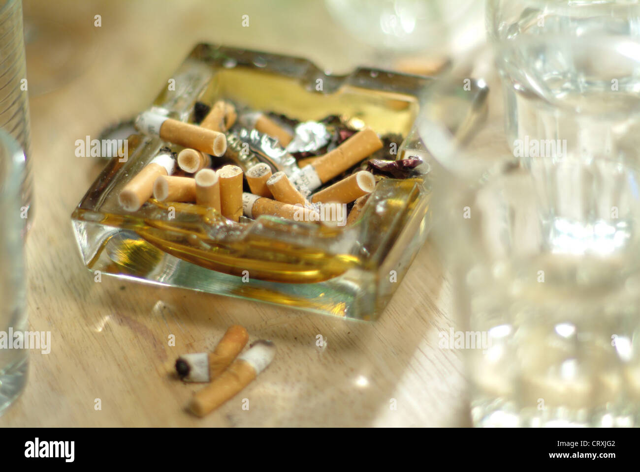 Full ashtray after a party Stock Photo - Alamy