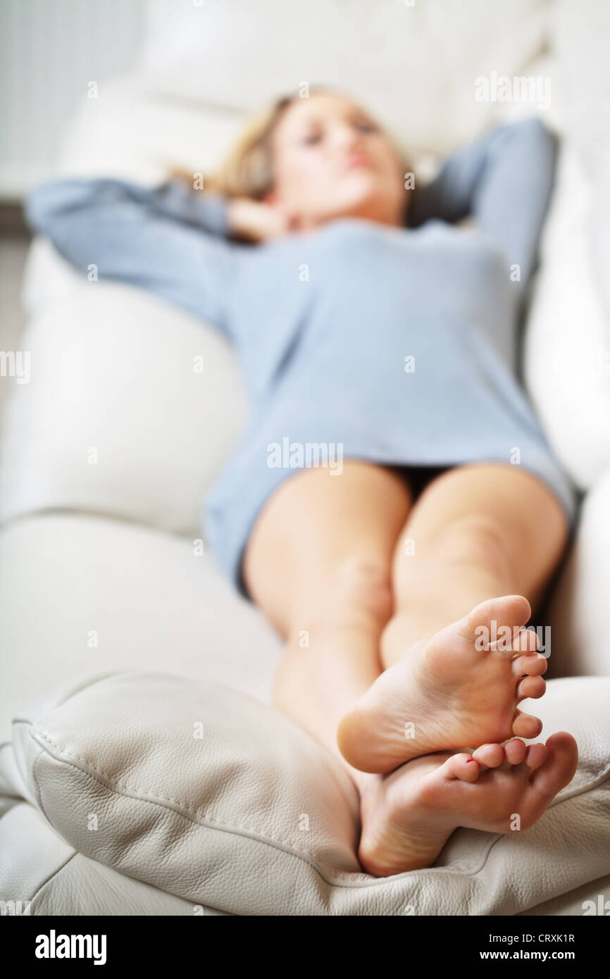 Barefoot Young Woman Lying On Sofa Shallow Depth Of Field Focus On