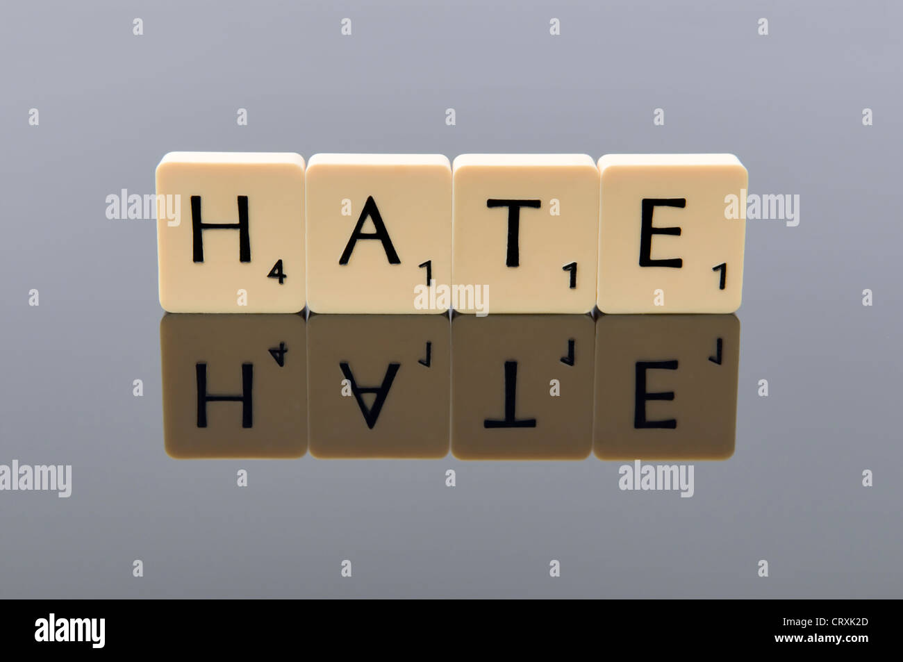 Scrabble letters spelling out the word hate with reflection, concepts ...