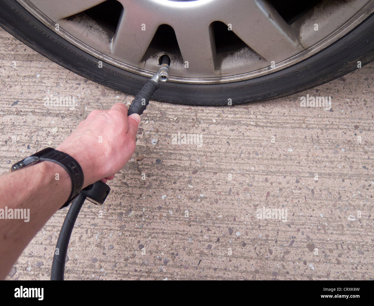 Checking car tyre pressures inflating tyres Stock Photo - Alamy