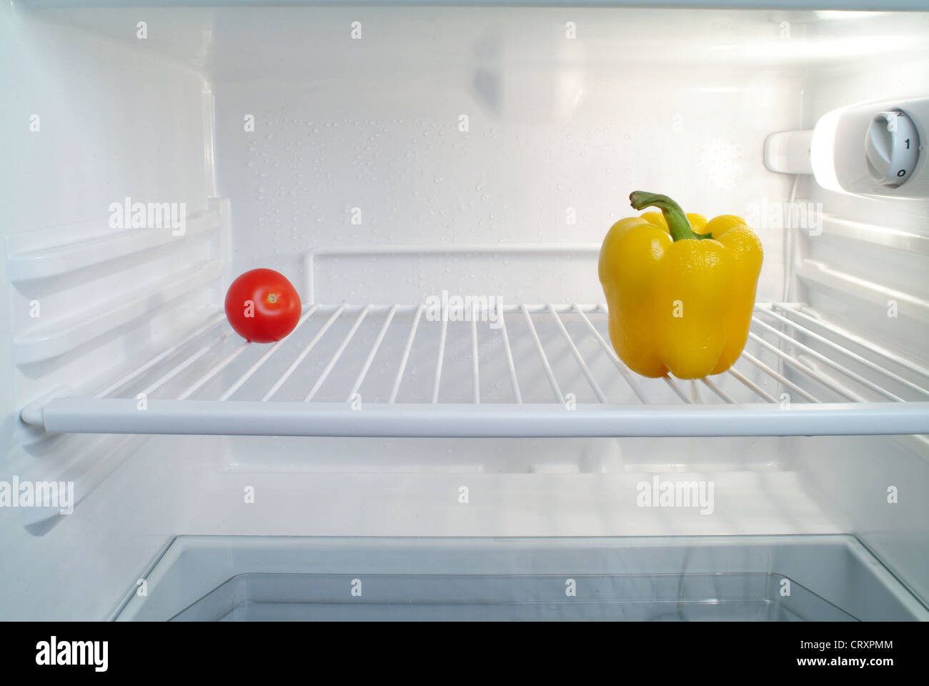 almost empty refrigerator with pepper and tomato Stock Photo - Alamy