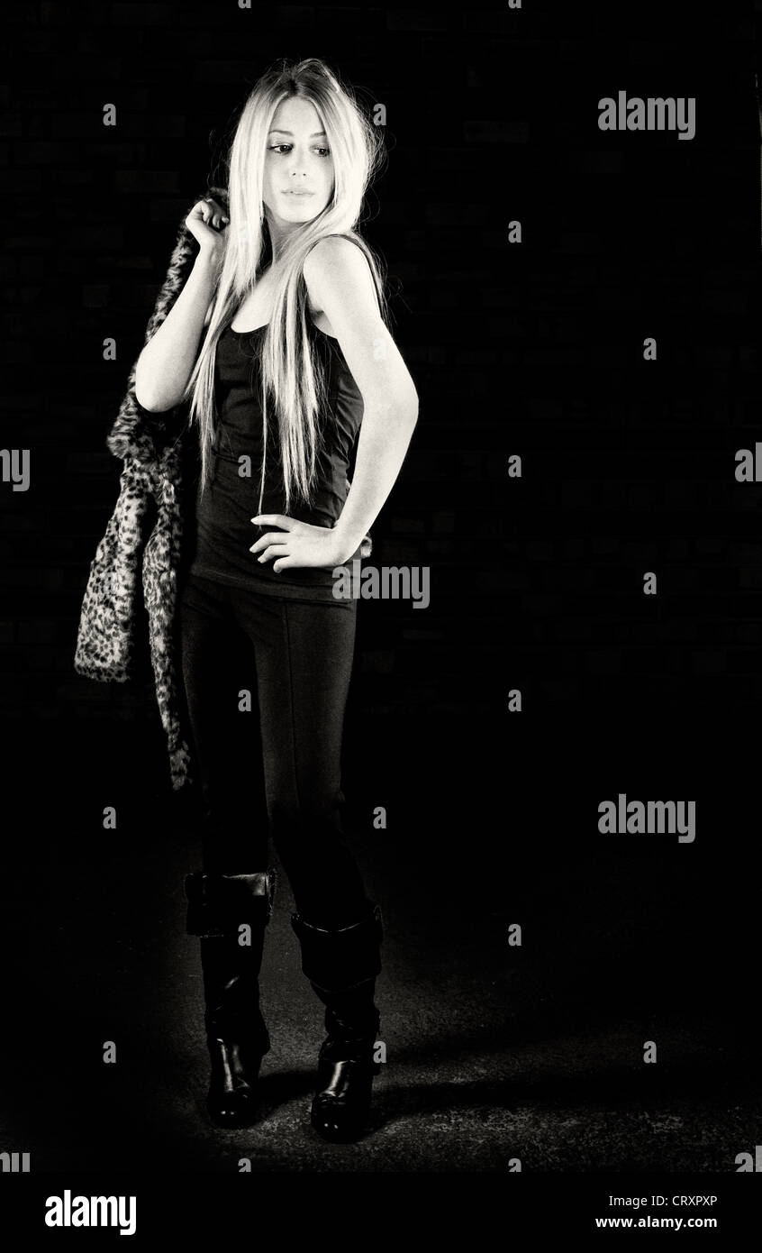 young woman model posing against a brick wall background Stock Photo ...