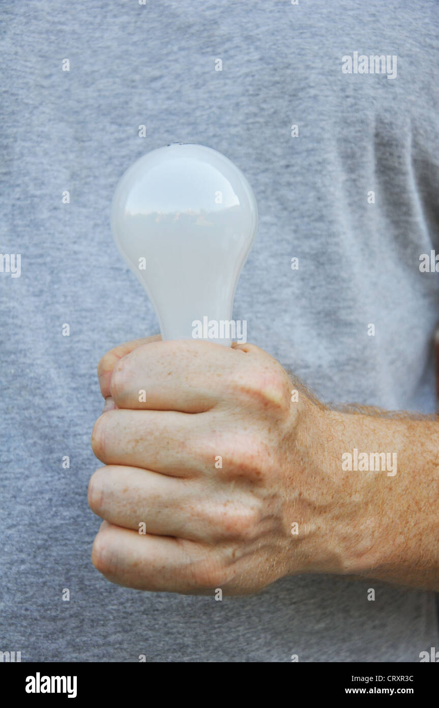 Man holding light bulb Stock Photo - Alamy