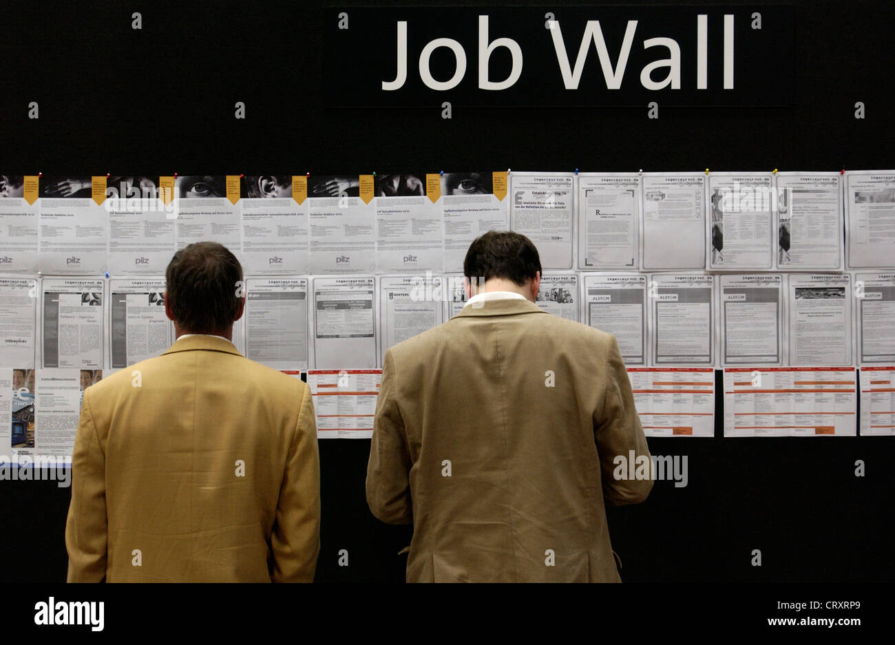 Two men in front of a job wall in Hanover Stock Photo - Alamy