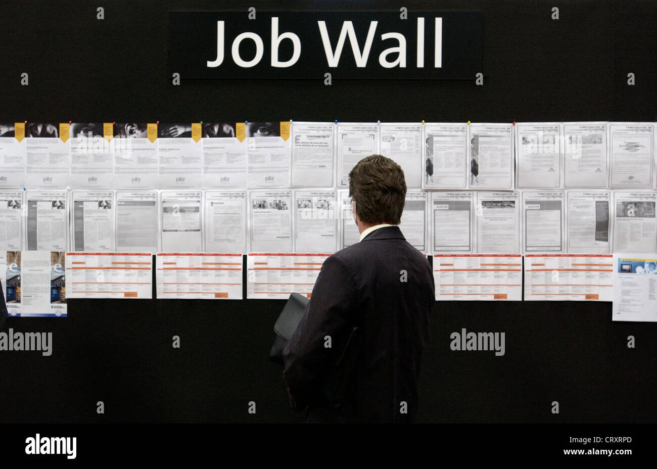 Man in front of a job wall in Hanover Stock Photo - Alamy