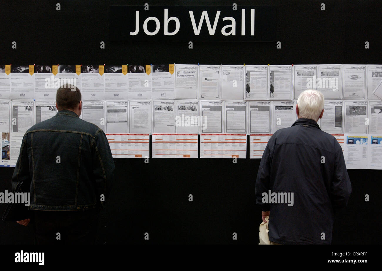 Two men in front of a job wall in Hanover Stock Photo - Alamy