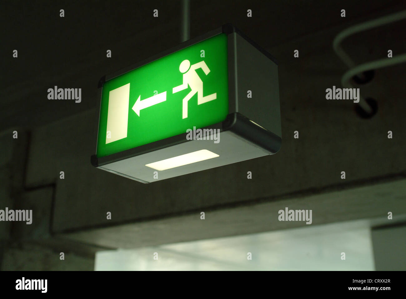 Gruenes, luminous emergency exit sign Stock Photo - Alamy