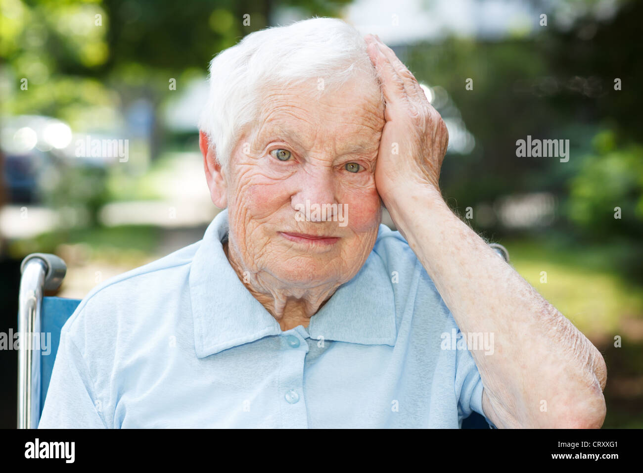 Happy senior lady in wheelchair smiling outside Stock Photo - Alamy