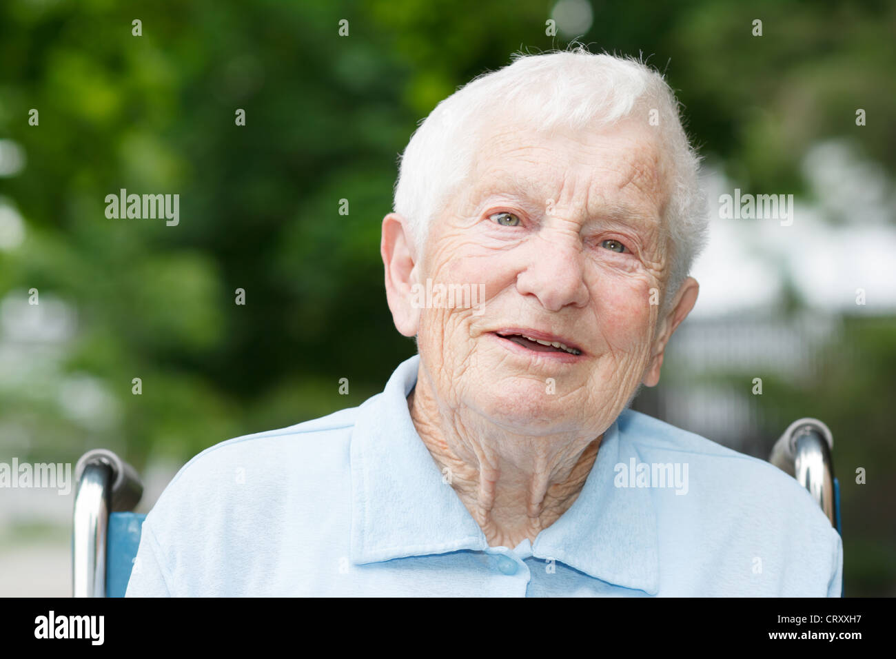 Happy senior lady in wheelchair smiling outside Stock Photo - Alamy