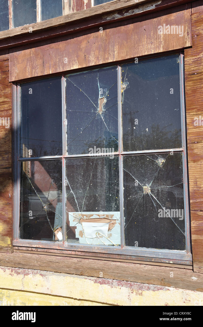 Window glass damaged by bullets Stock Photo - Alamy