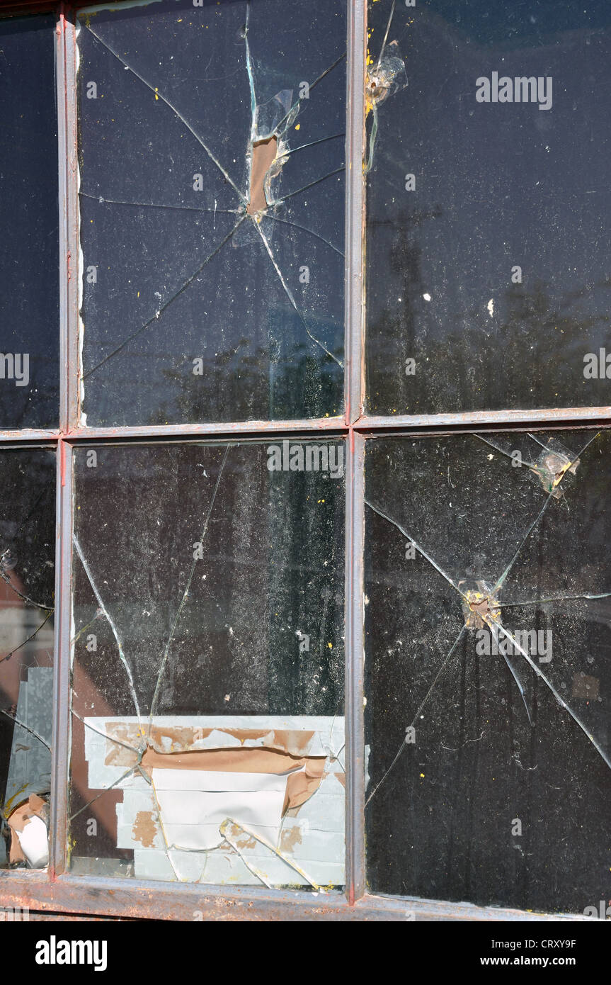 Window glass damaged by bullets Stock Photo - Alamy
