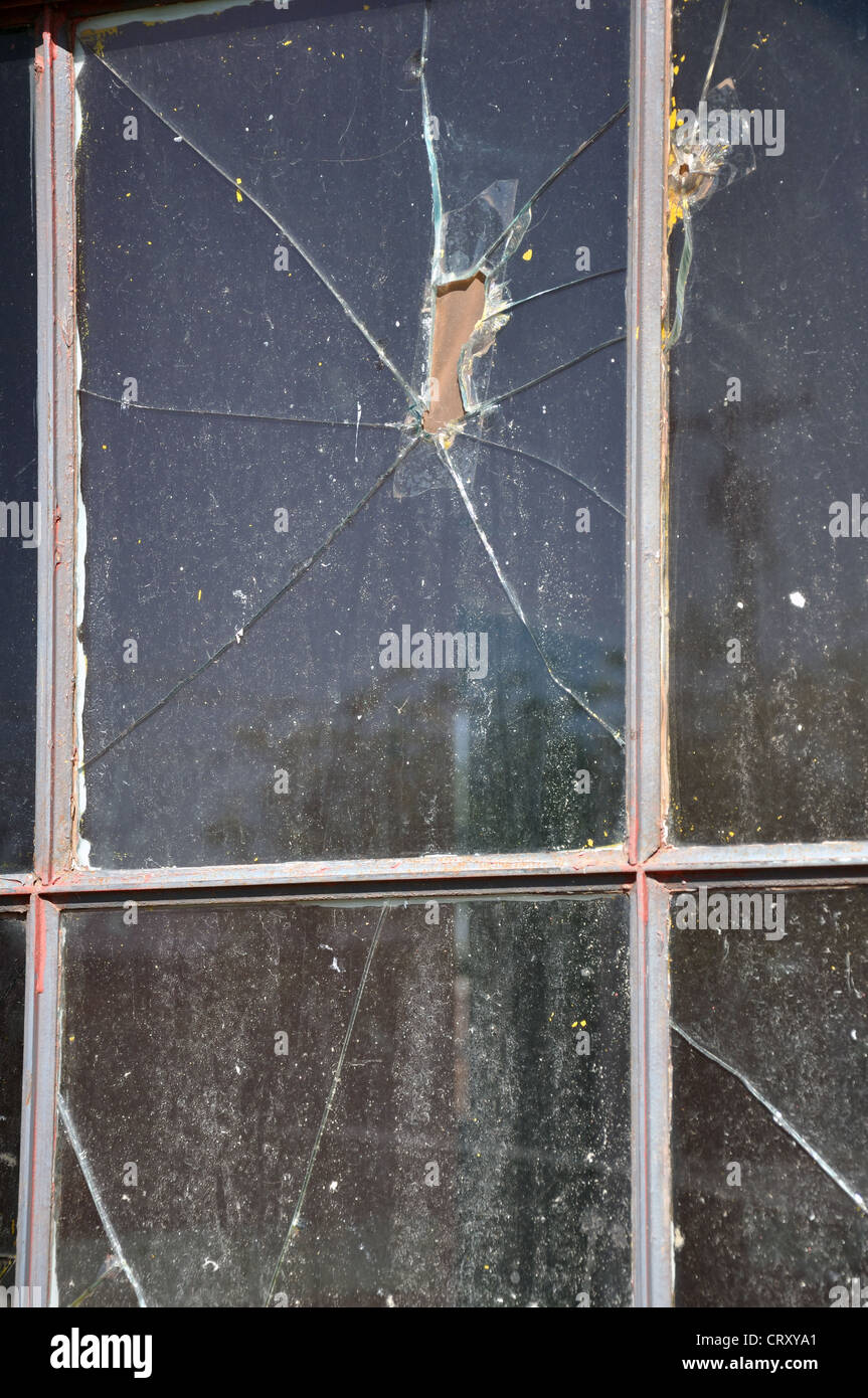 Window glass damaged by bullets Stock Photo - Alamy