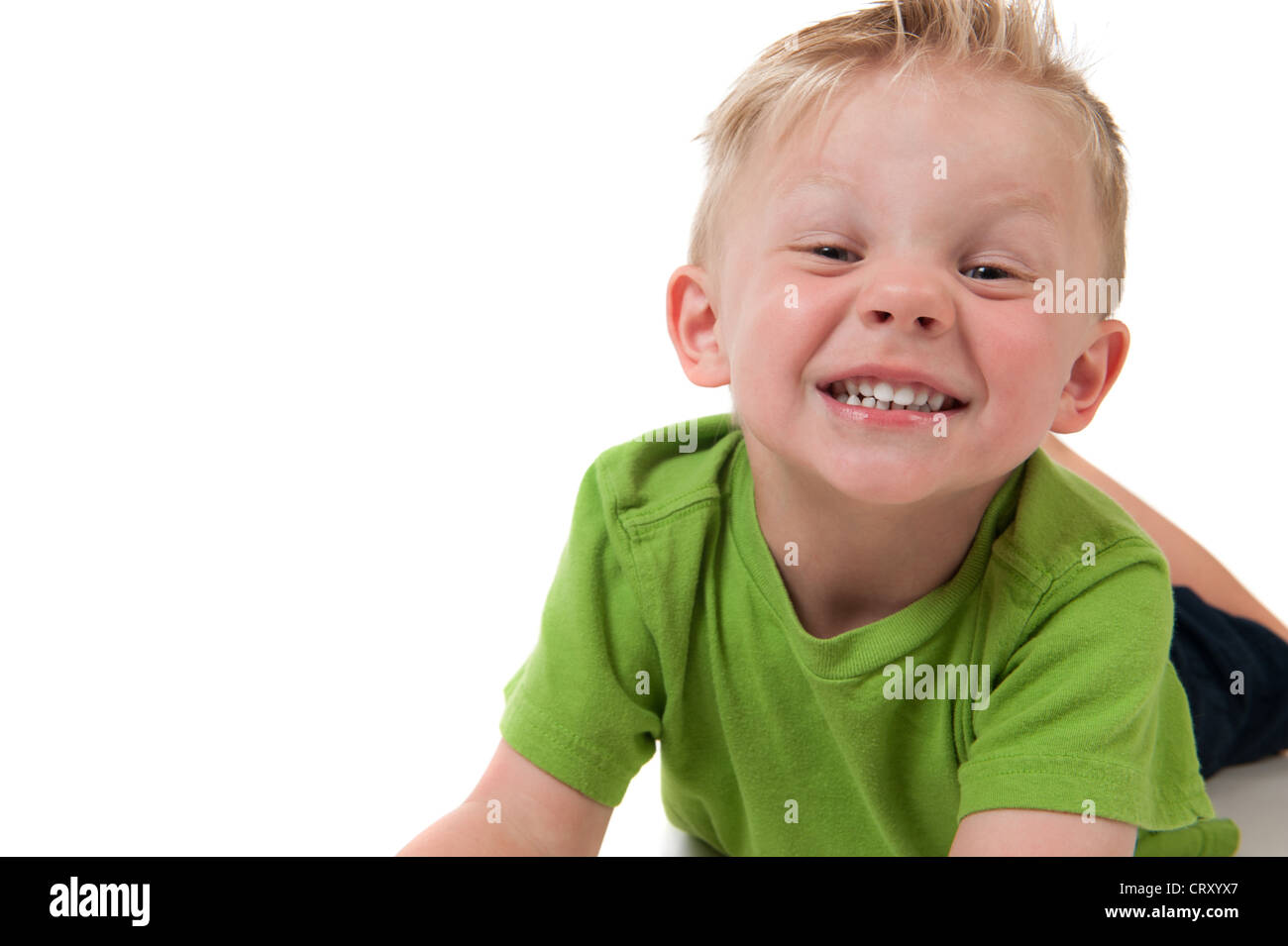 Young boy laying down and smiling on white Stock Photo - Alamy