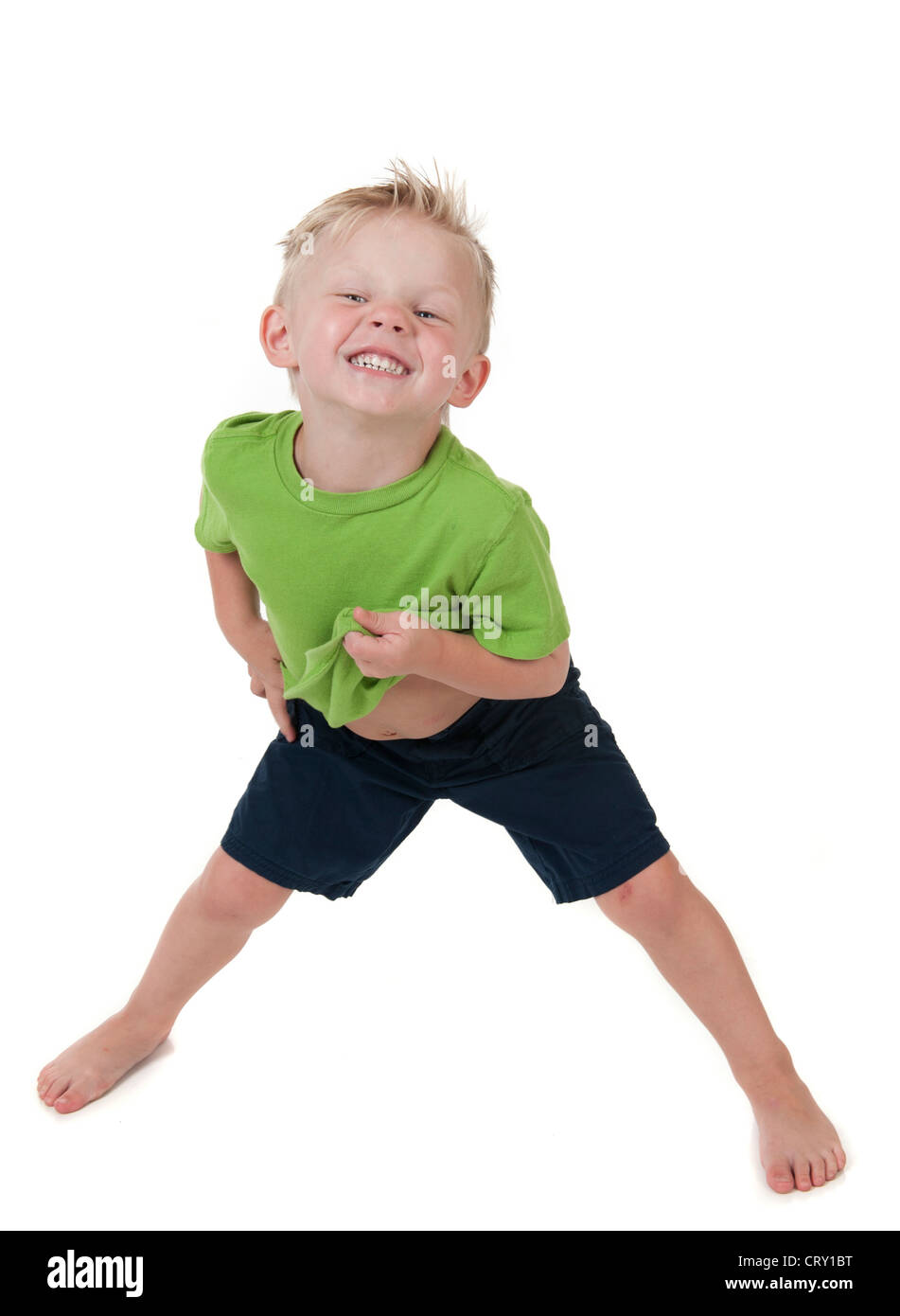 Young silly boy in a green shirt on a white background Stock Photo - Alamy