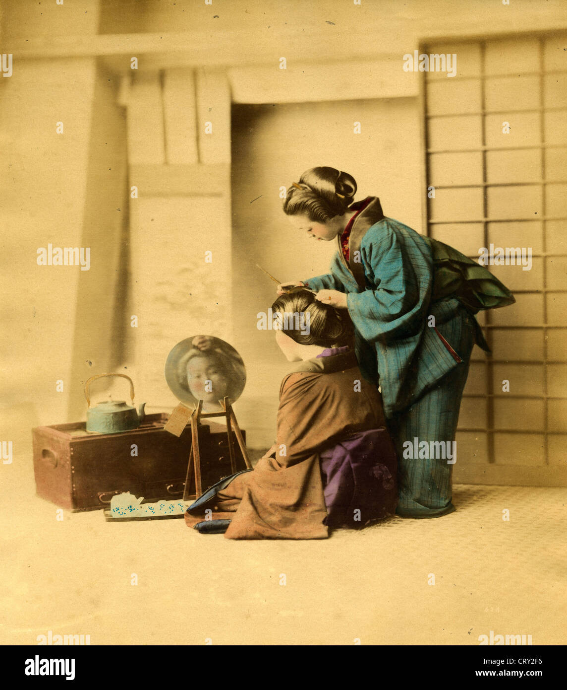 Colorized photo of a woman in traditional Japanese dress styling the ...