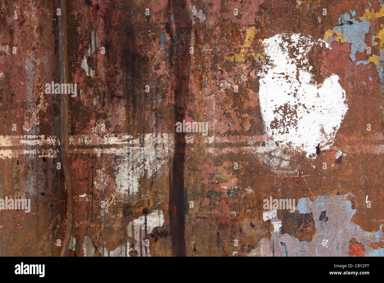 Rusted dockside wall with paint patches in different colors at a ...