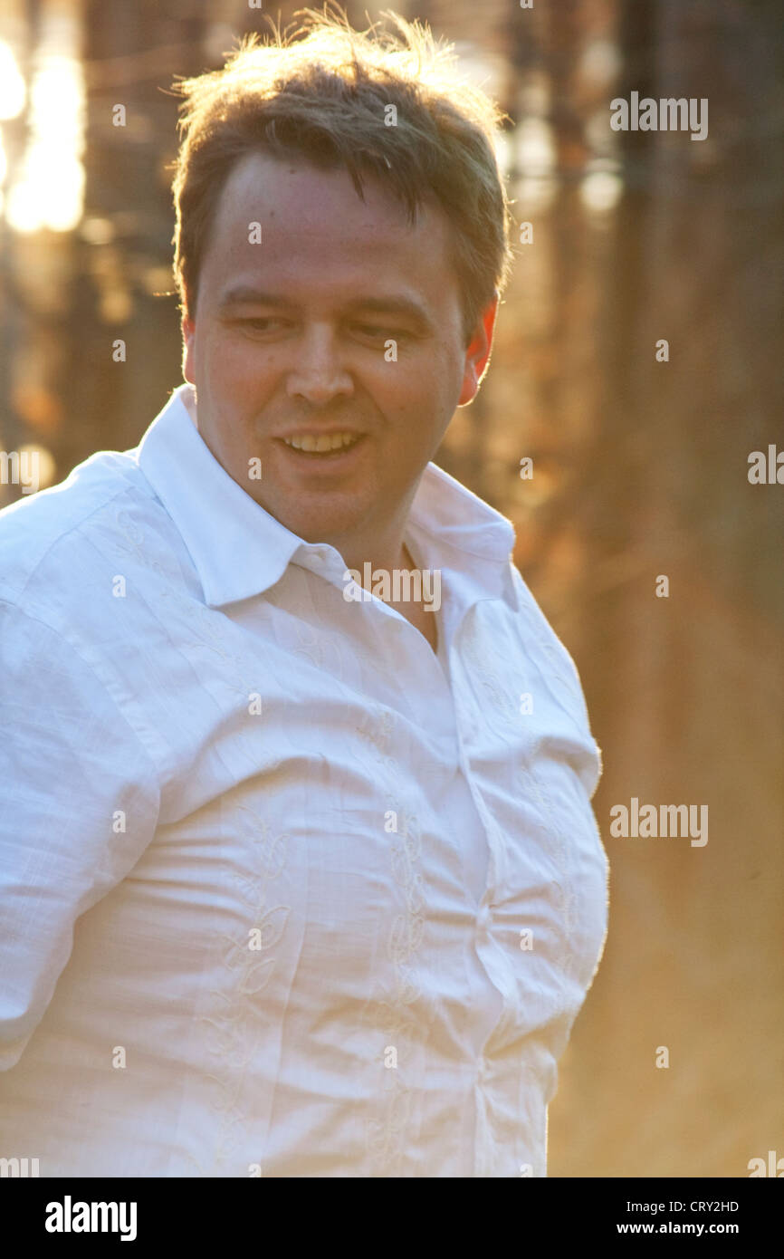 Happy active man age 40 playing outside highlighted by sun. Champlin ...