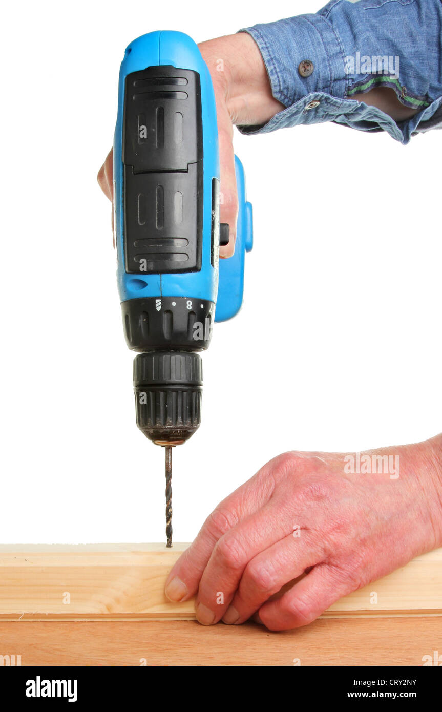 Closeup of hands drilling into wood with a cordless drill Stock Photo ...