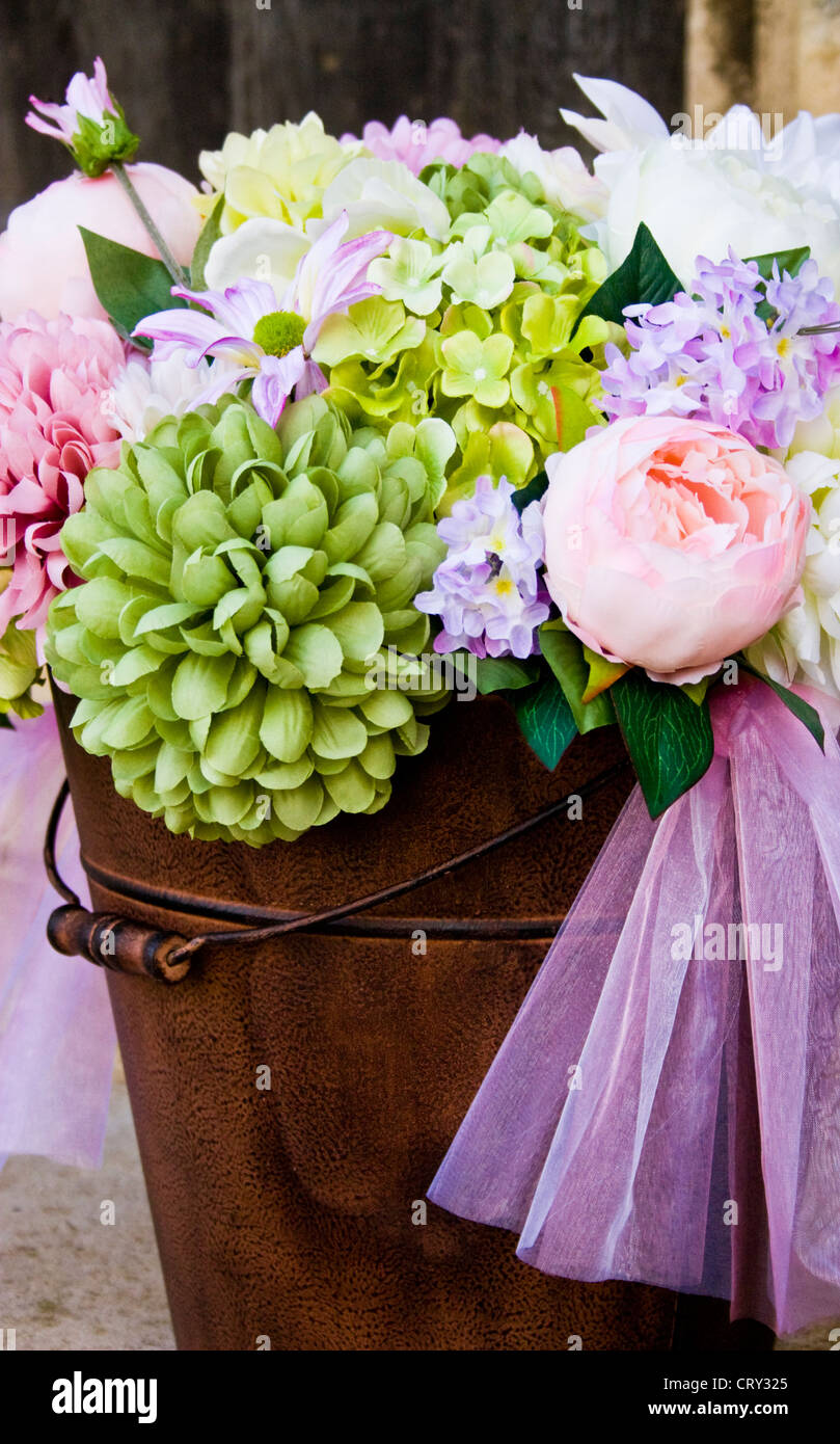 Fake wedding flowers in a copper bucket Stock Photo - Alamy
