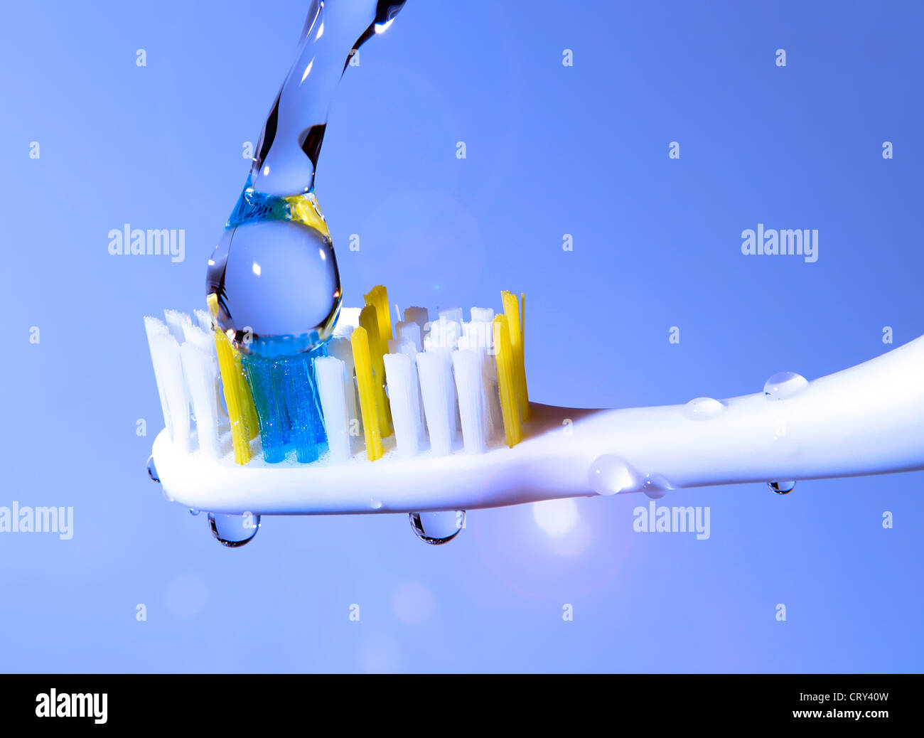 toothbrush under the running water Stock Photo - Alamy