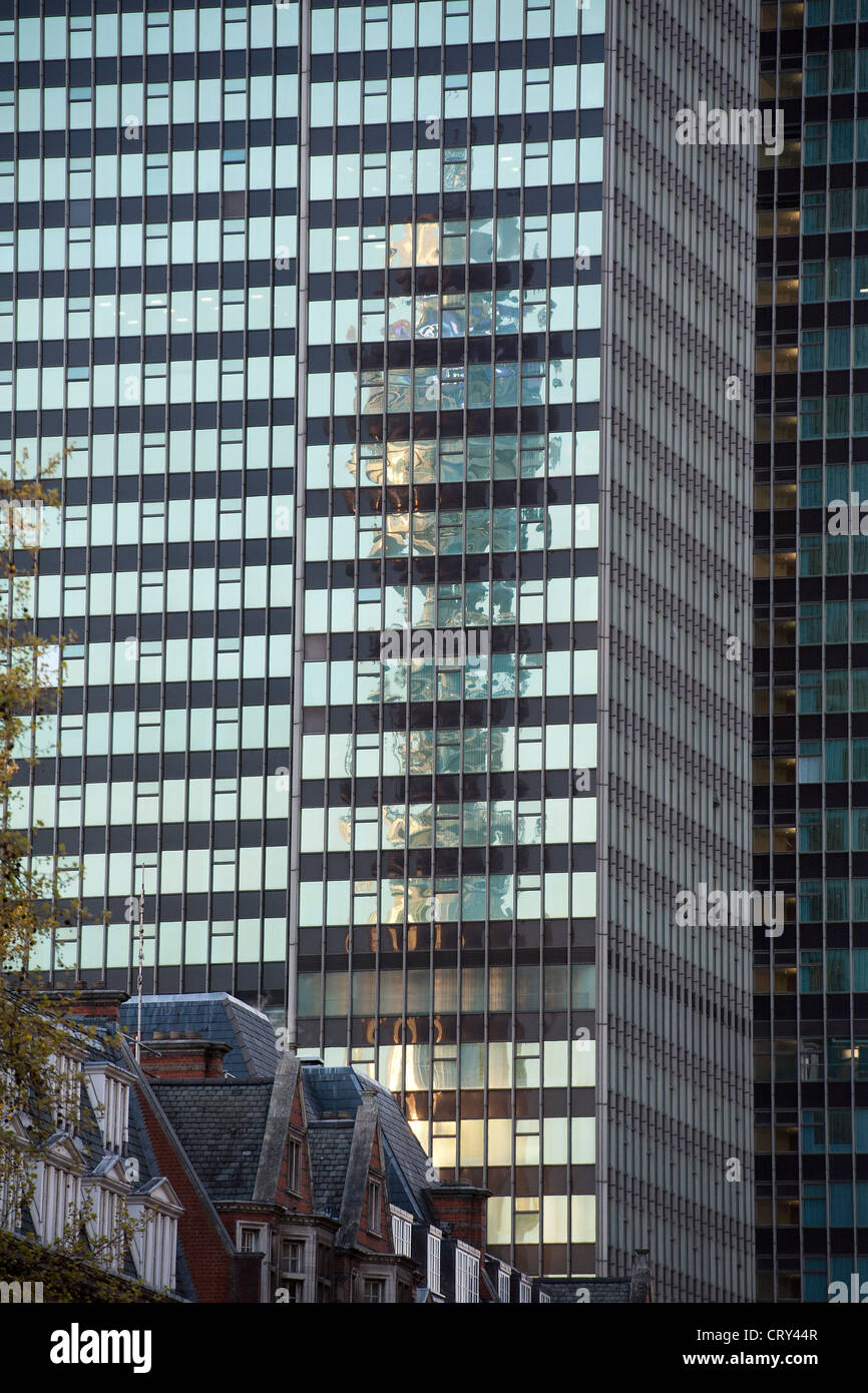 The post office tower is reflected in the windows of an office block ...
