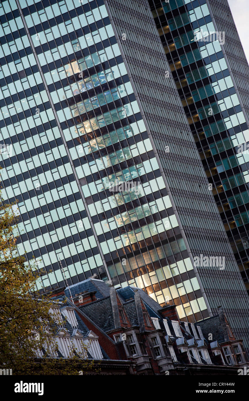 The post office tower is reflected in the windows of an office block ...