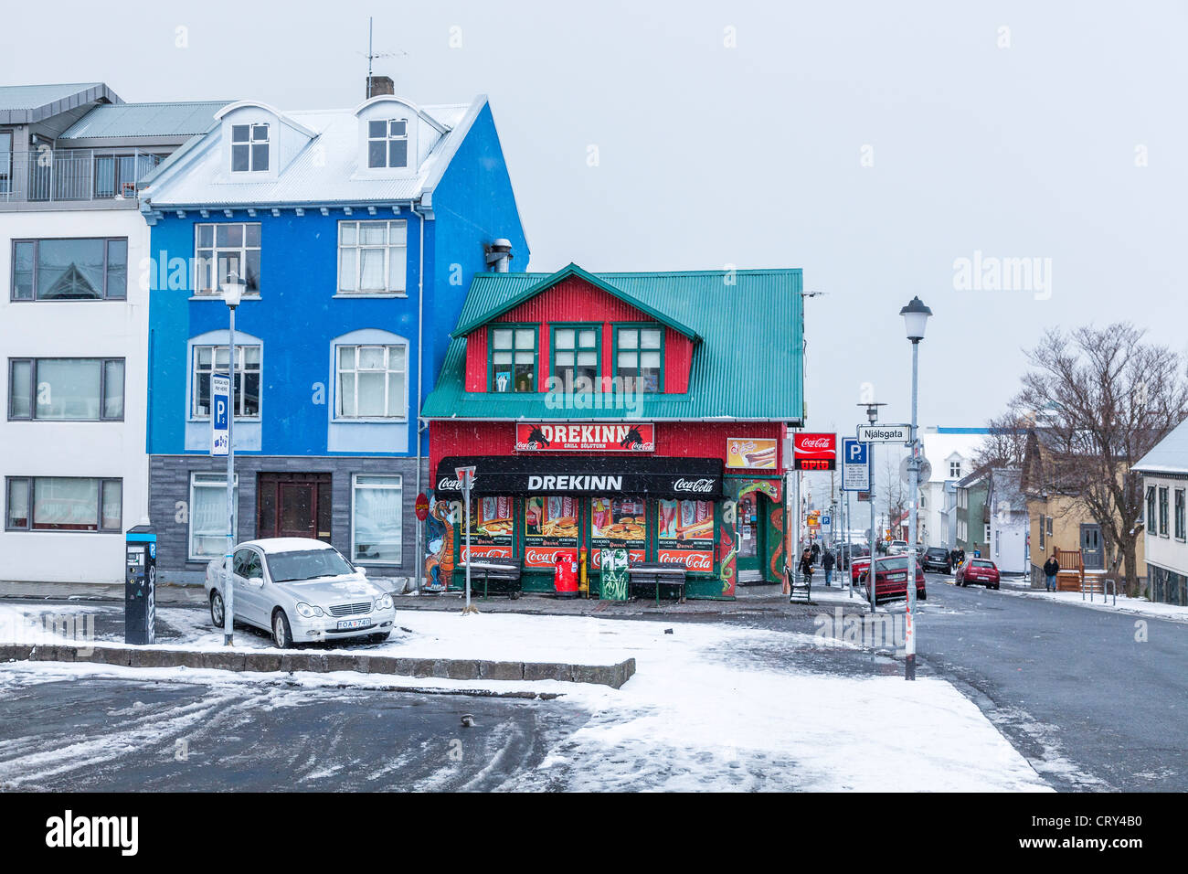 Reykjavik, Iceland, street scene in the snow, with shop/cafe and blue ...