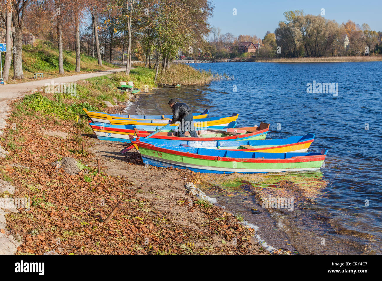 Colorful rowing boats on moored on the lakeside, Lake Galve, Trakai ...