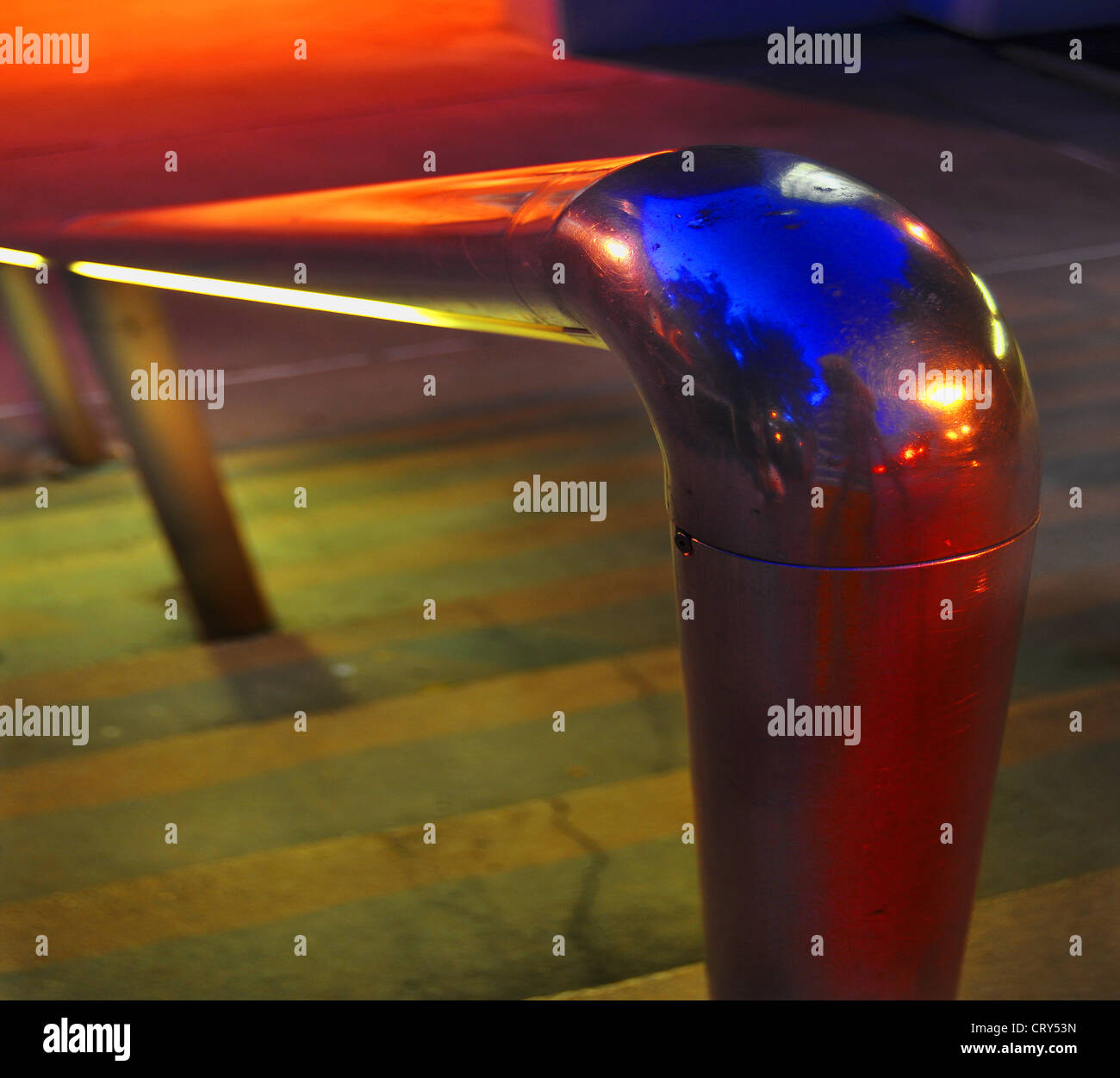 A shinny metal rail reflecting light at night with steps Stock Photo ...