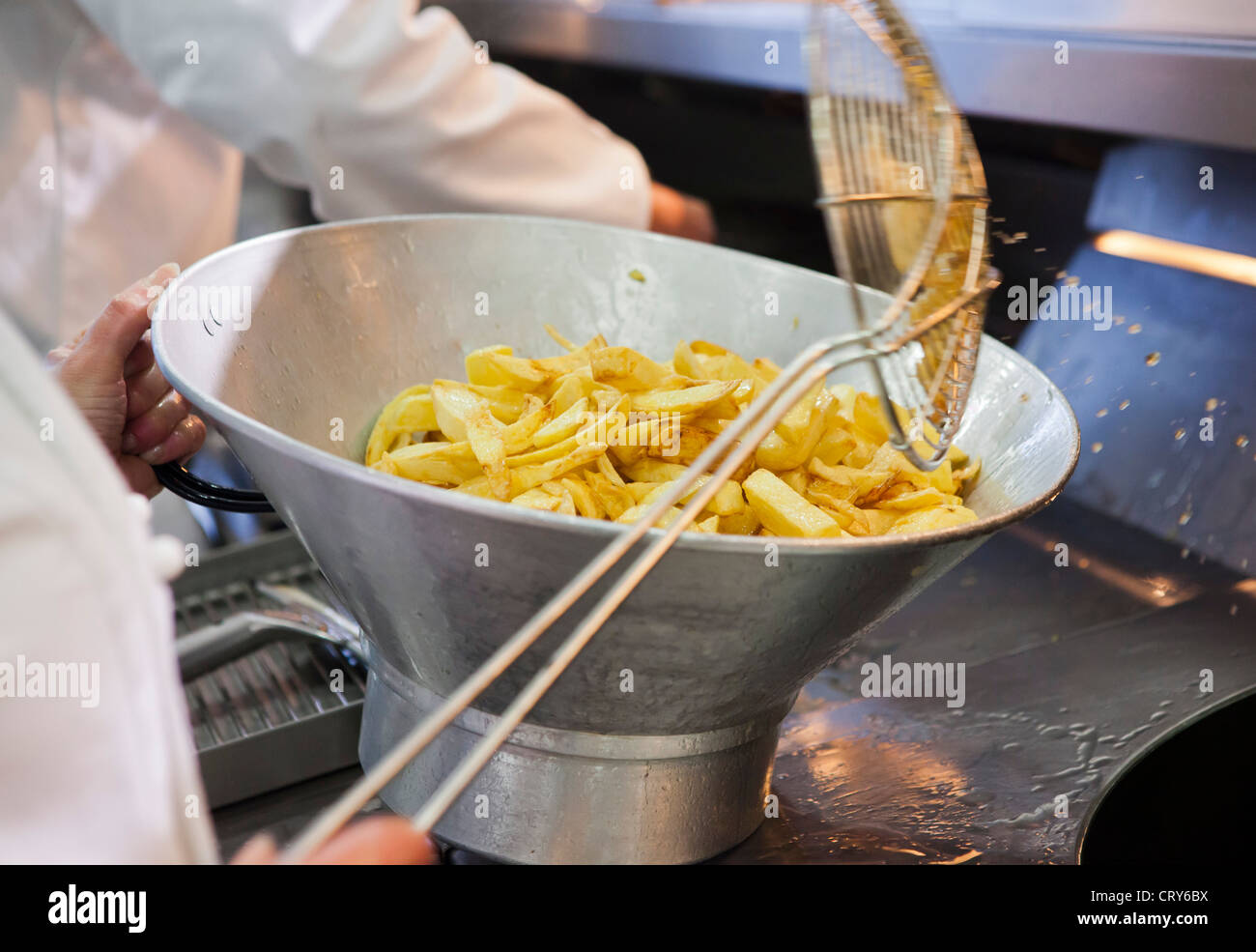 CChips being fried in traditional British chip shop Gloucestershire, UK ...