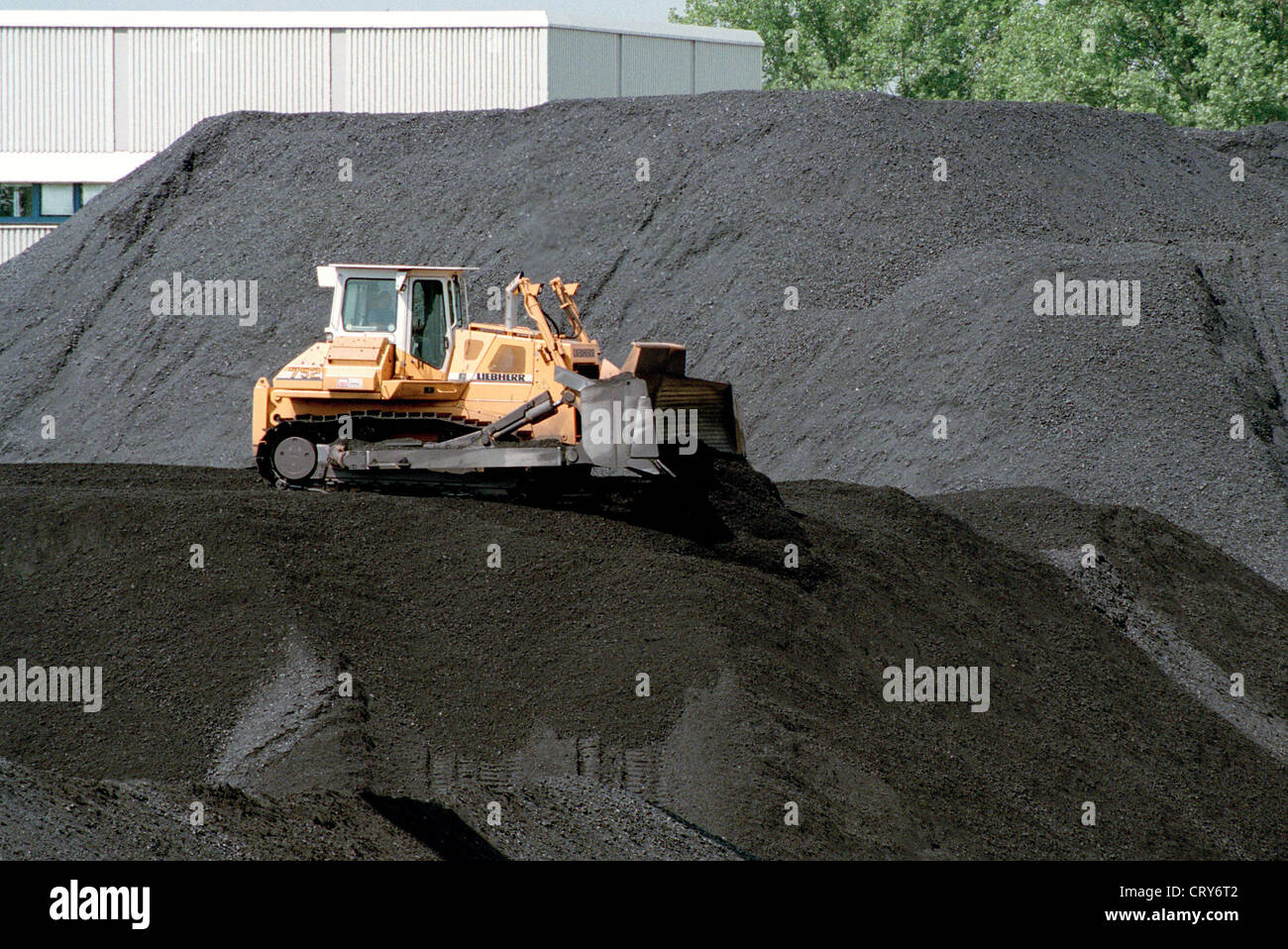 Bulldozer on a coal pile Stock Photo - Alamy
