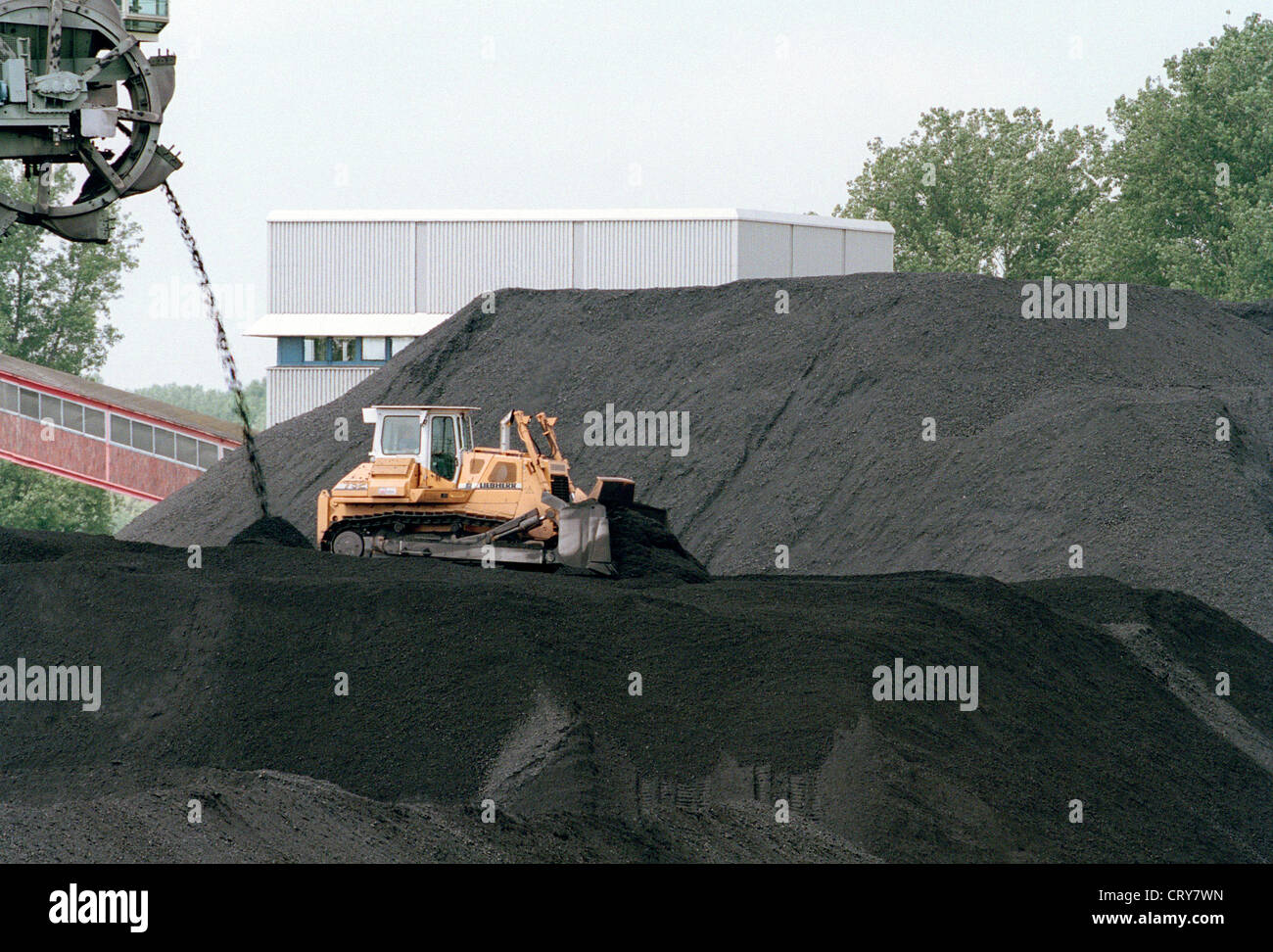 Bulldozer on a coal pile Stock Photo - Alamy
