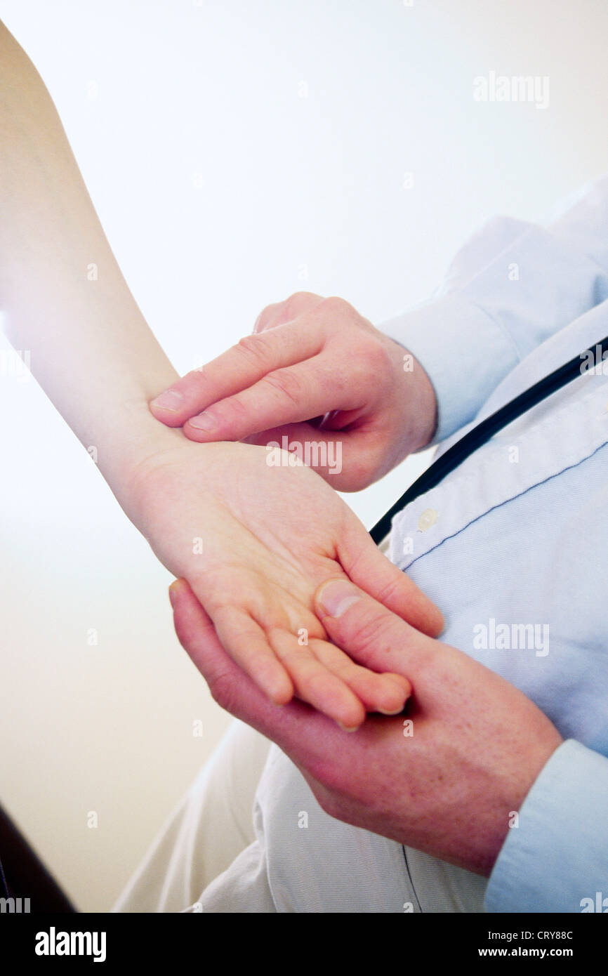 TAKING A WOMAN'S PULSE Stock Photo - Alamy
