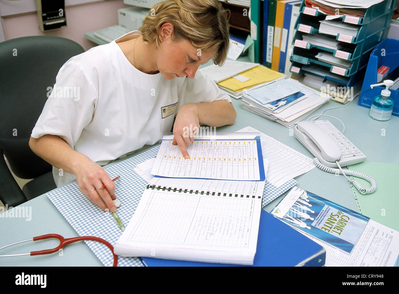 NURSE WITH PATIENT'S RECORD Stock Photo - Alamy