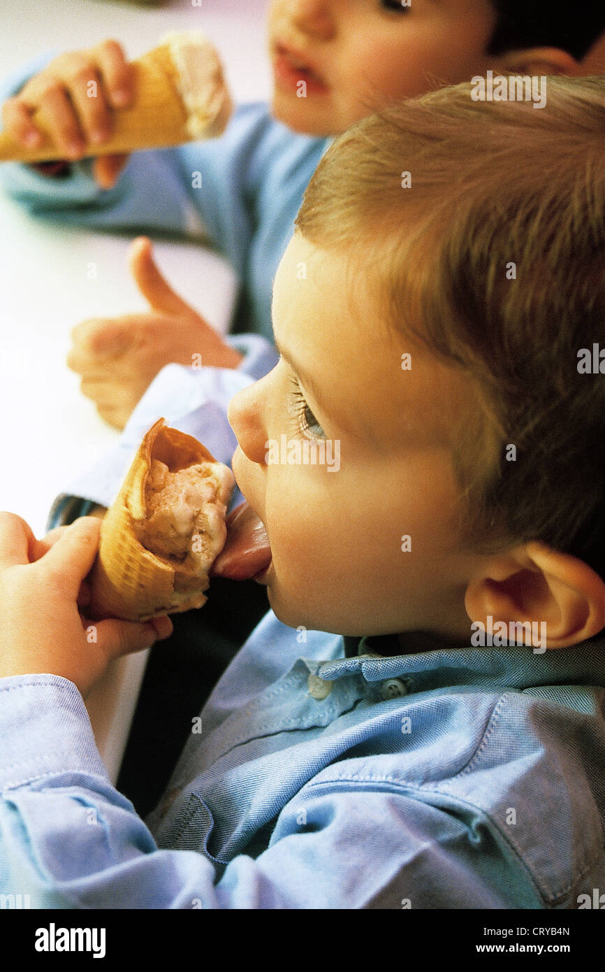 CHILD EATING SWEETS Stock Photo - Alamy