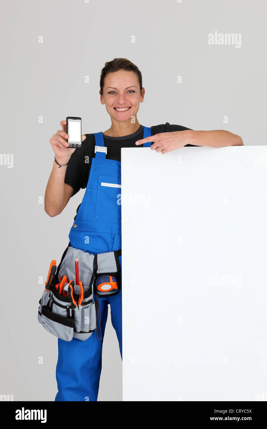 Young female laborer with Smartphone Stock Photo - Alamy