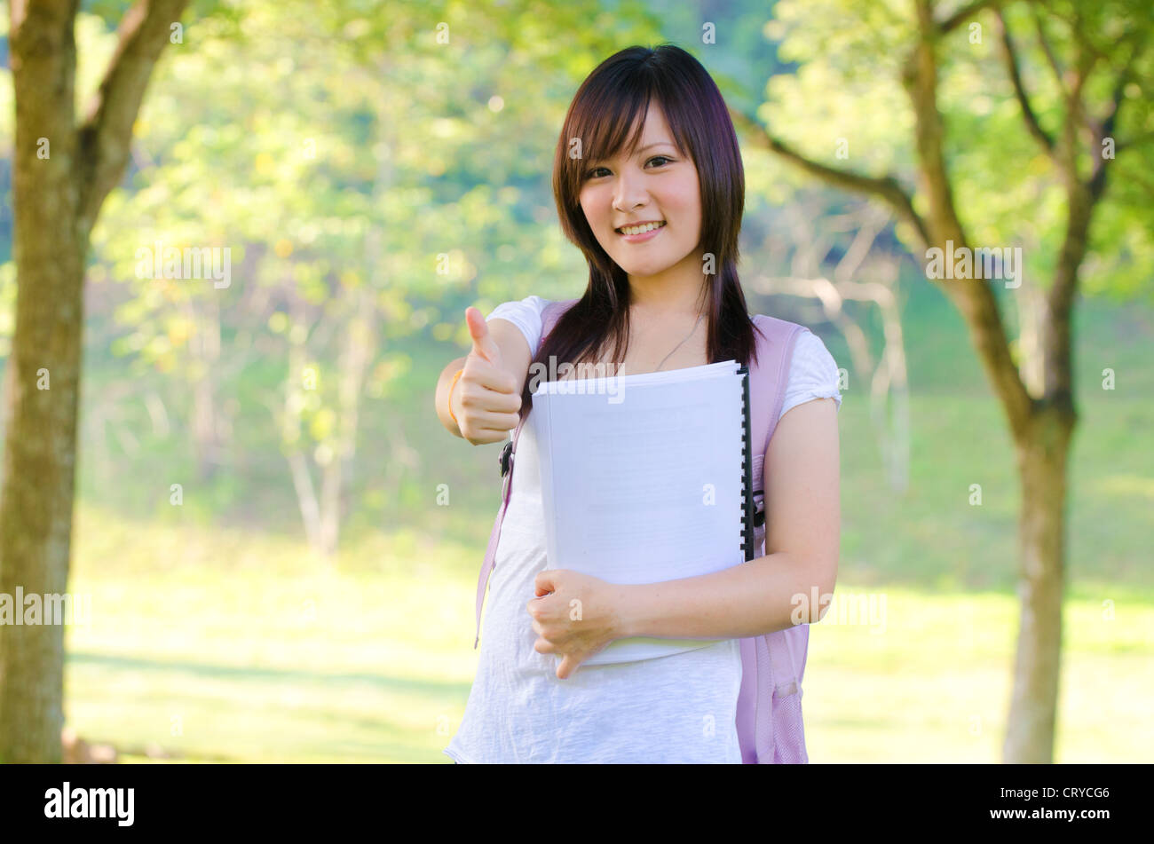 College student standing outside campus, green park Stock Photo - Alamy