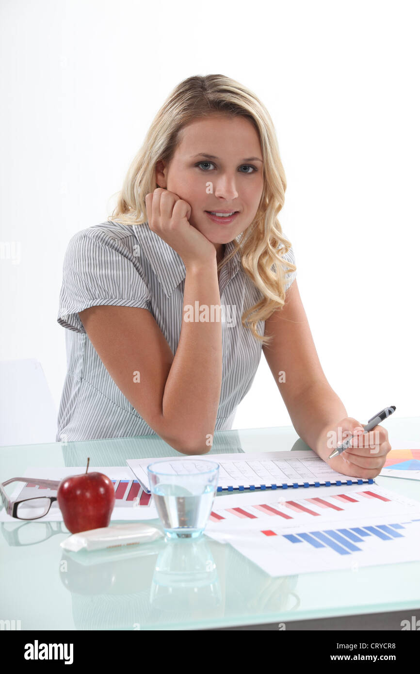 Blond woman working with financial graphs Stock Photo - Alamy