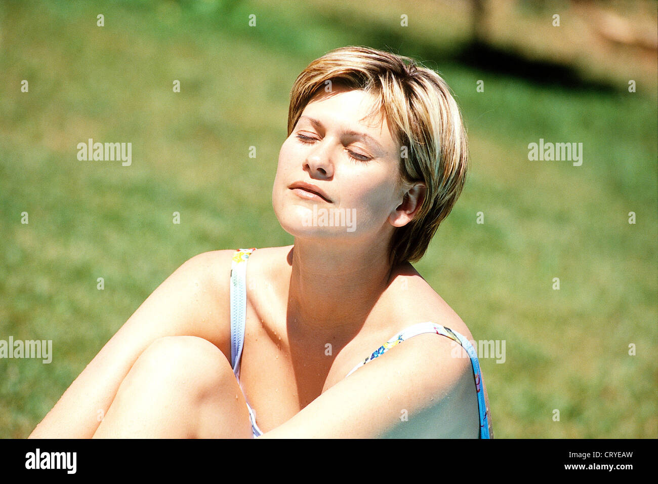 WOMAN TANNING IN SUMMER Stock Photo - Alamy