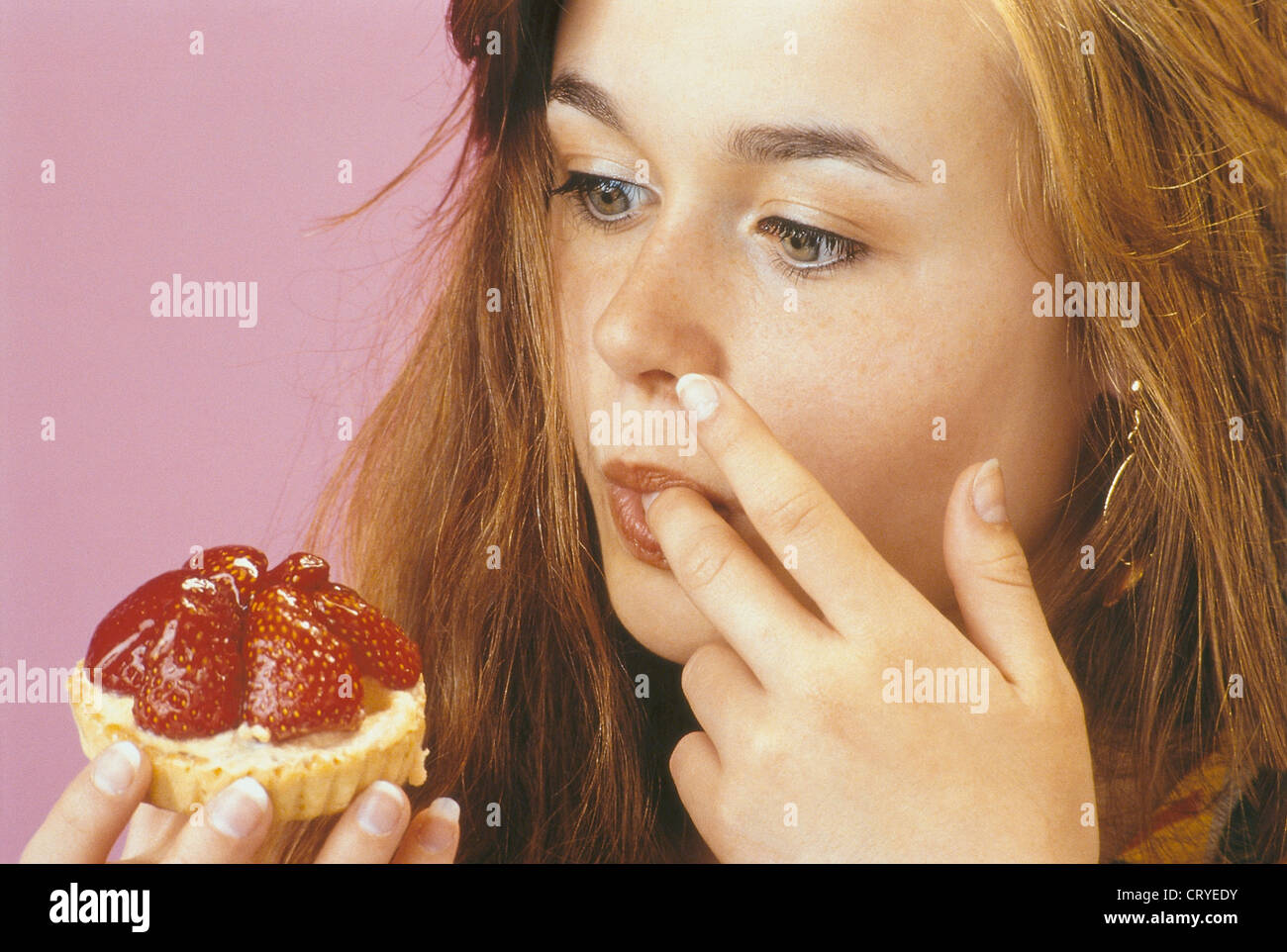 WOMAN EATING SWEETS Stock Photo - Alamy
