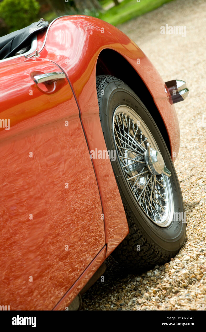 The rear wing and wheel of classic red vintage sports car with spoked ...