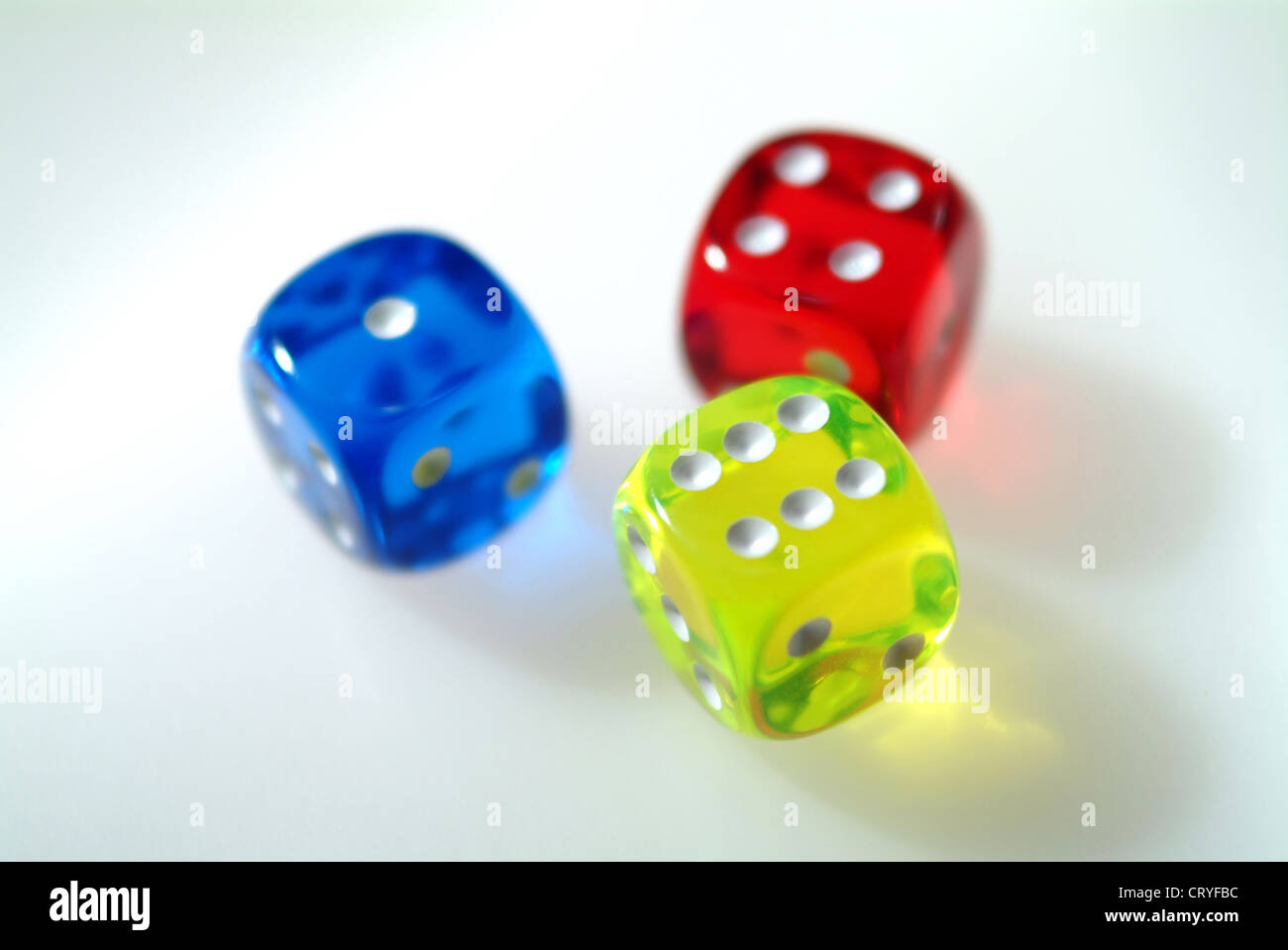 three different colored dice Stock Photo - Alamy
