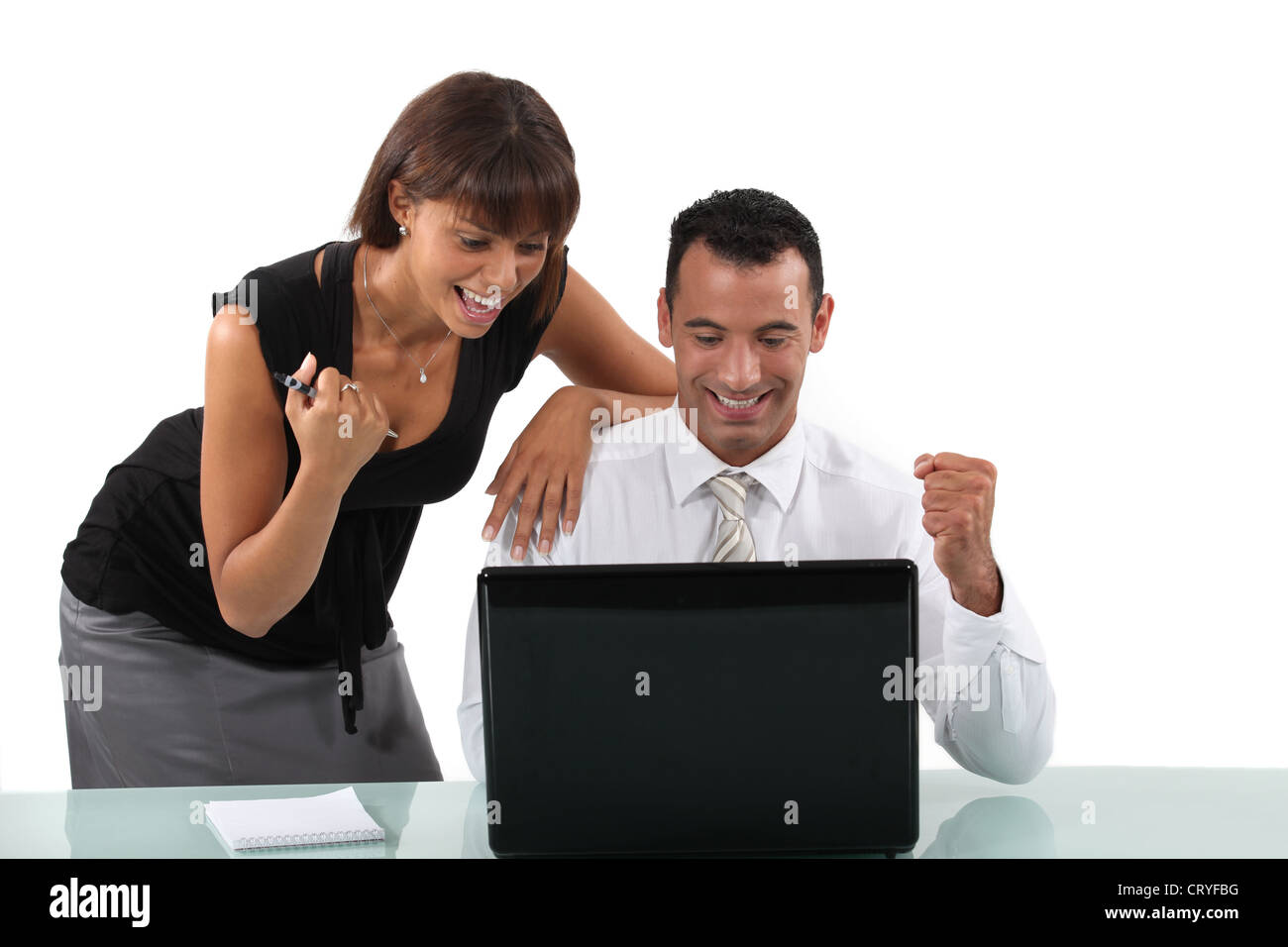 Excited business duo with laptop Stock Photo - Alamy