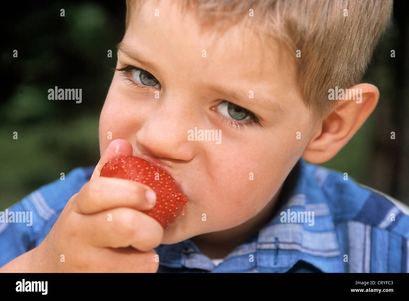 CHILD EATING FRUIT Stock Photo - Alamy