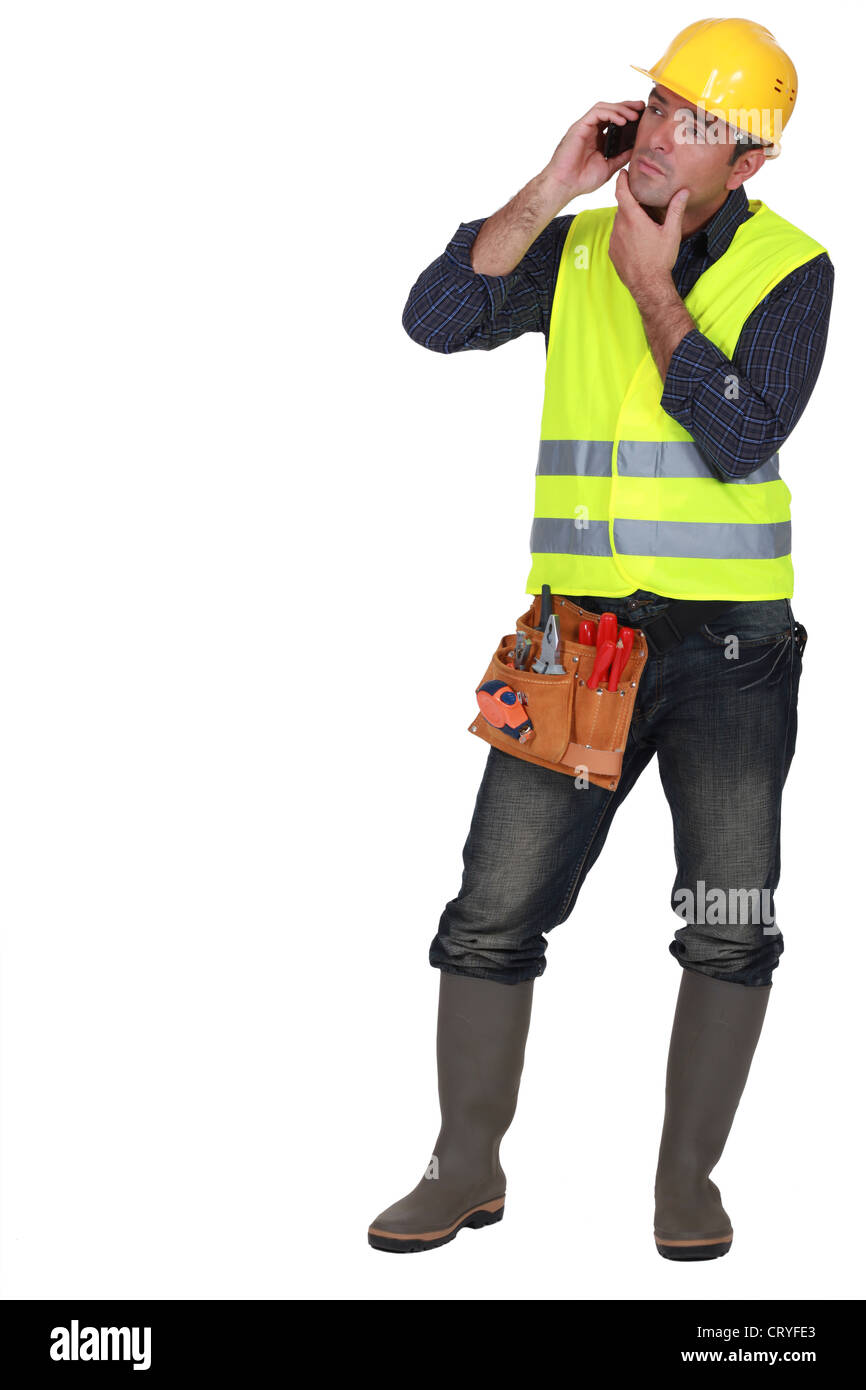 Foreman thinking during phone call Stock Photo - Alamy