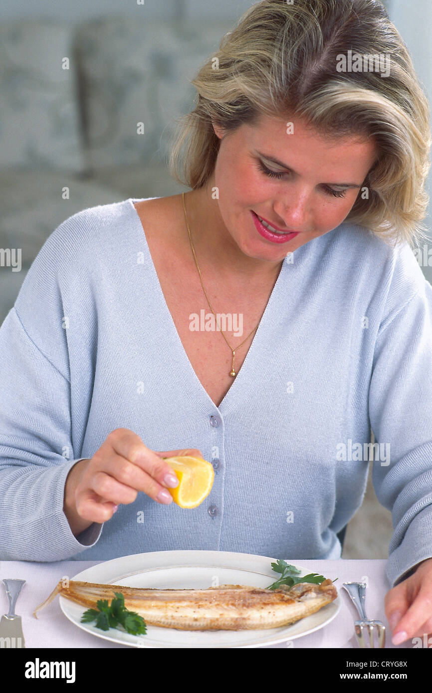 WOMAN EATING FISH Stock Photo - Alamy