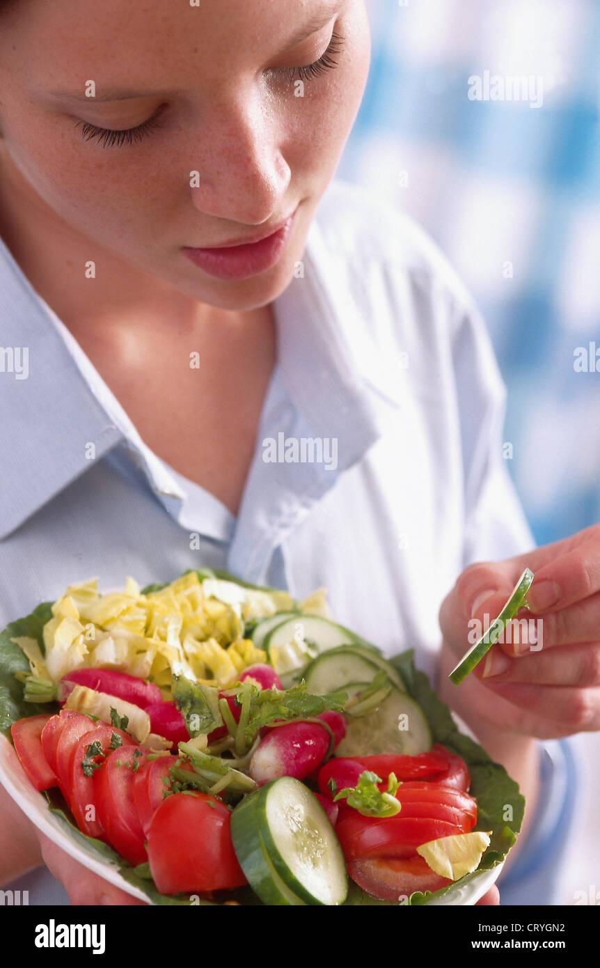 WOMAN EATING RAW VEGETABLES Stock Photo - Alamy