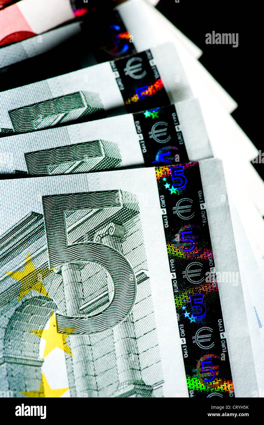 Closeup of the denomination and security hologram on fanned open pile ...